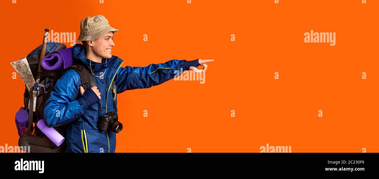 Hicker with big backpack pointing at free space Stock Photo - Alamy