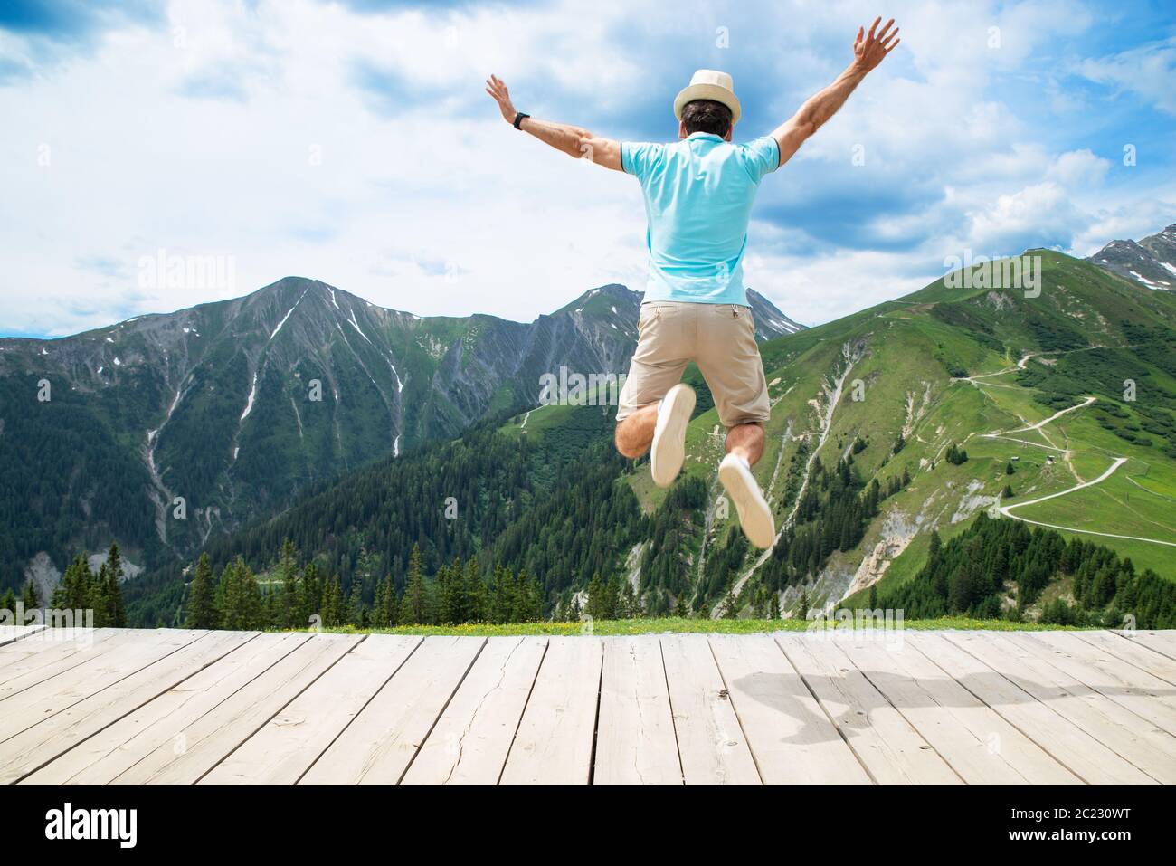 Traveler man jumping mountains hi-res stock photography and images - Alamy