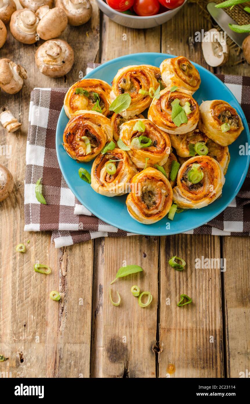 Pizza snails in puff pastry with ham, cheese and mushrooms Stock Photo ...
