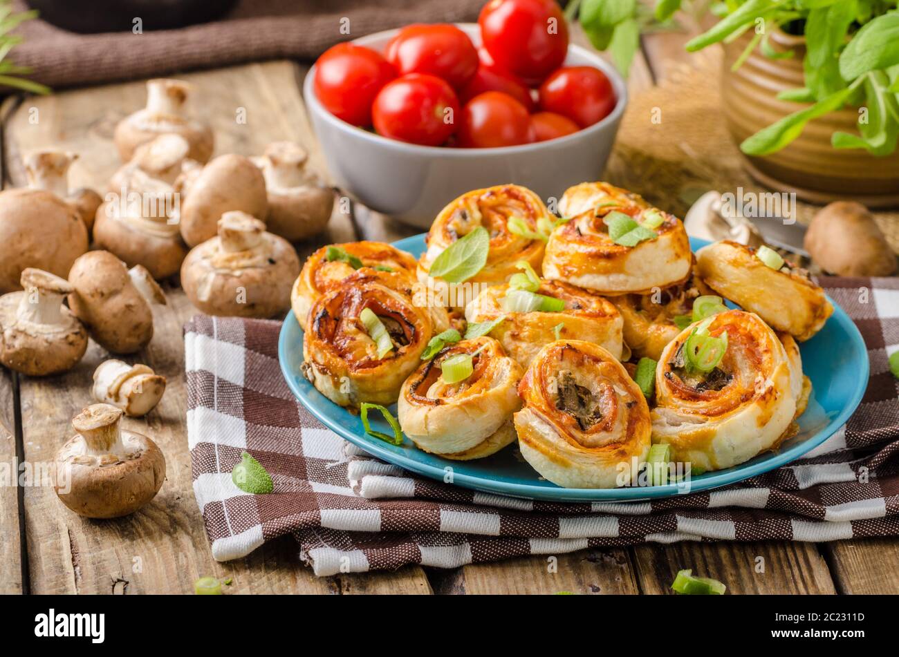 Pizza snails in puff pastry with ham, cheese and mushrooms Stock Photo ...