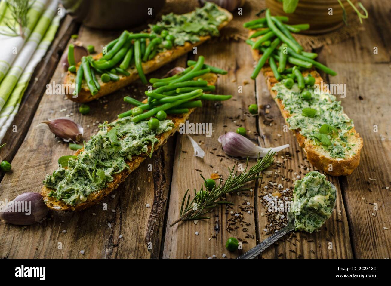 Healthy rustic baguette with herb butter and vegetables Stock Photo - Alamy