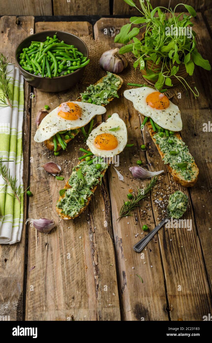 Healthy rustic baguette with herb butter and vegetables Stock Photo - Alamy