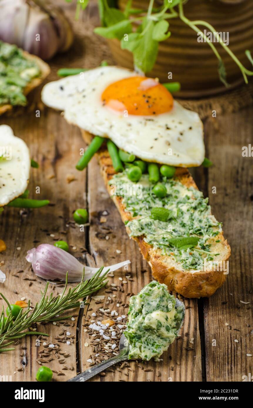 Healthy rustic baguette with herb butter and vegetables Stock Photo - Alamy