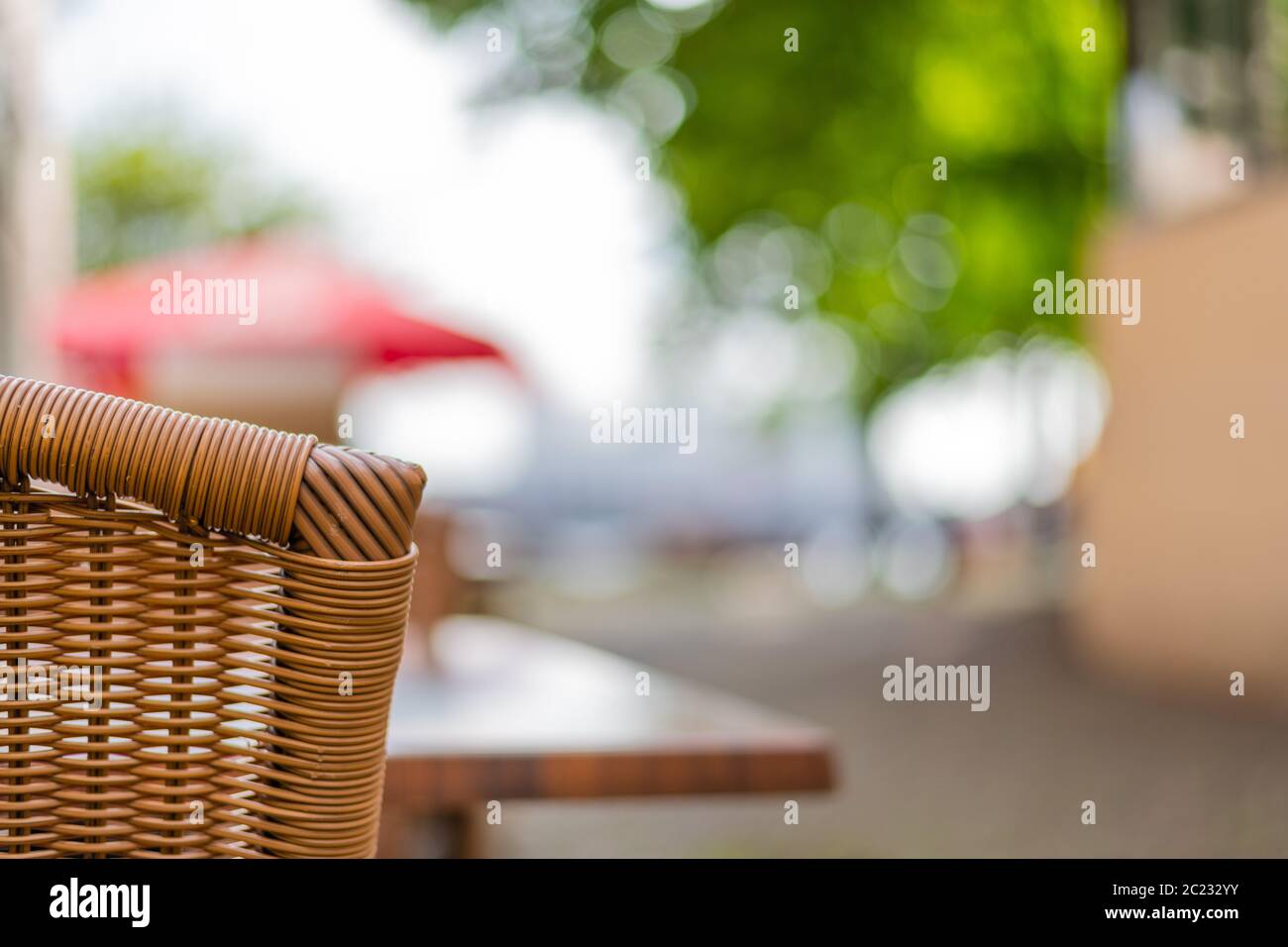 wooden chairs and tables in a pedestrian area in front of a coffee ...