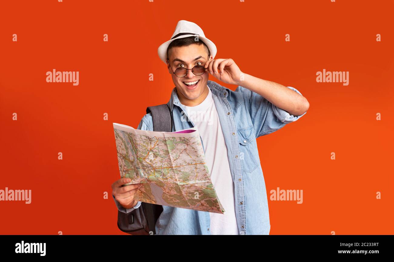 Inspired tourist with city map making sightseeing Stock Photo - Alamy
