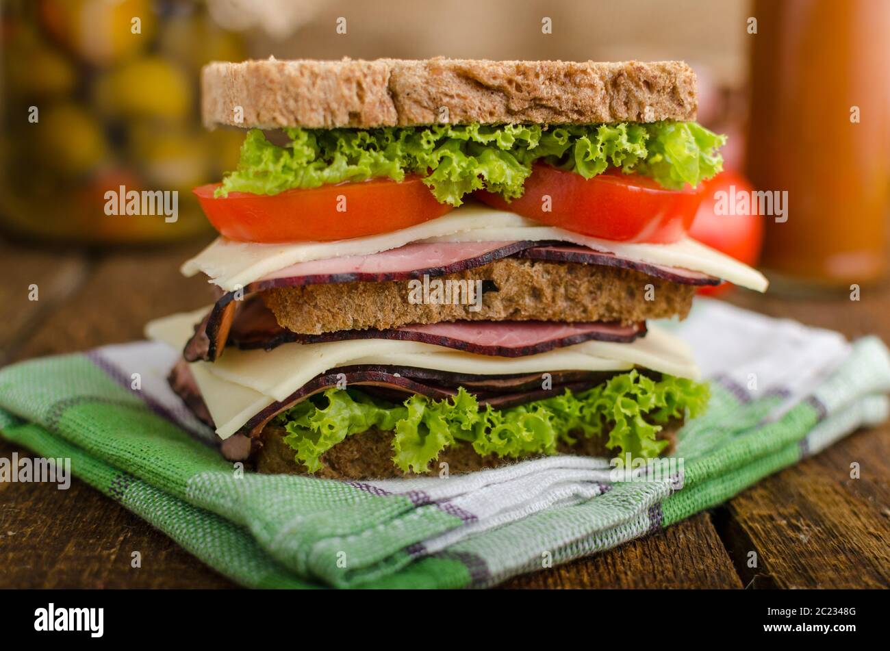 Sandwich with fresh smoked meat, cheese, lettuce and tomato with ...