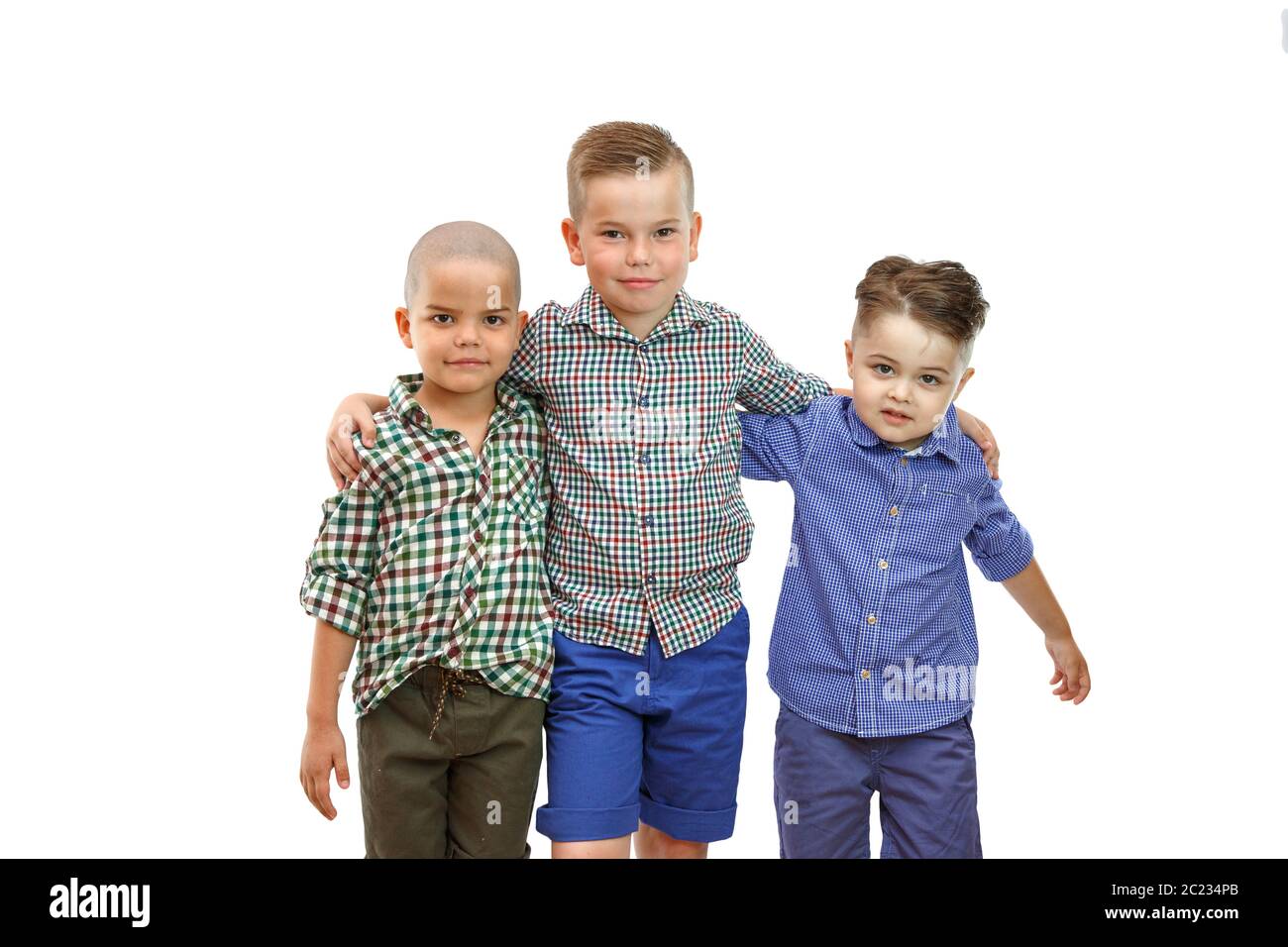 Three fashion cute boys are standing together on white isolated ...