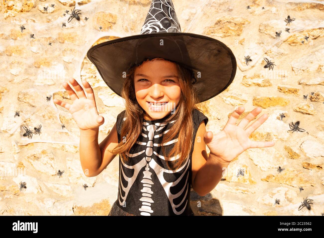 Portrait in Halloween skeleton costume of a girl with spooky hand ...
