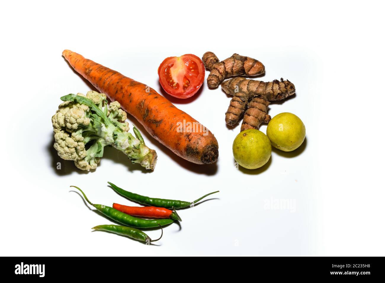 Multiple vegetables like cauliflower carrot red and green chili lemon ...