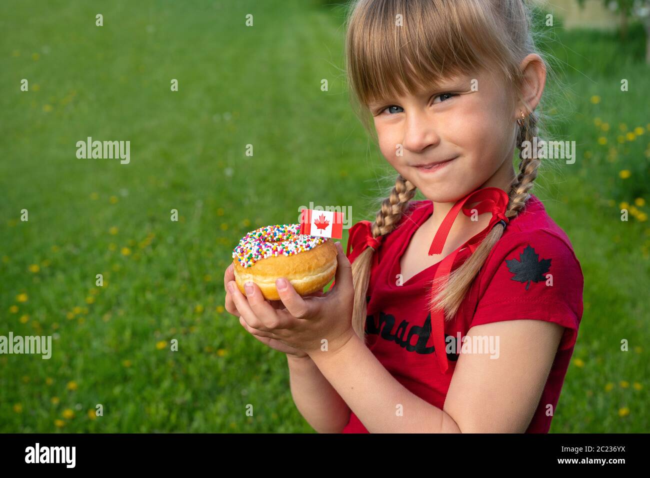 Happy Canada Day Celebration Concept. Smiling girl is holding a ...