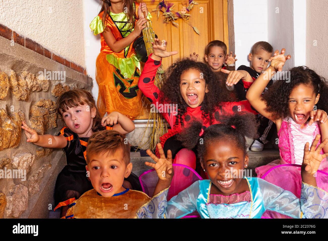 Large diverse group of spooky looking kids in Halloween costumes ...