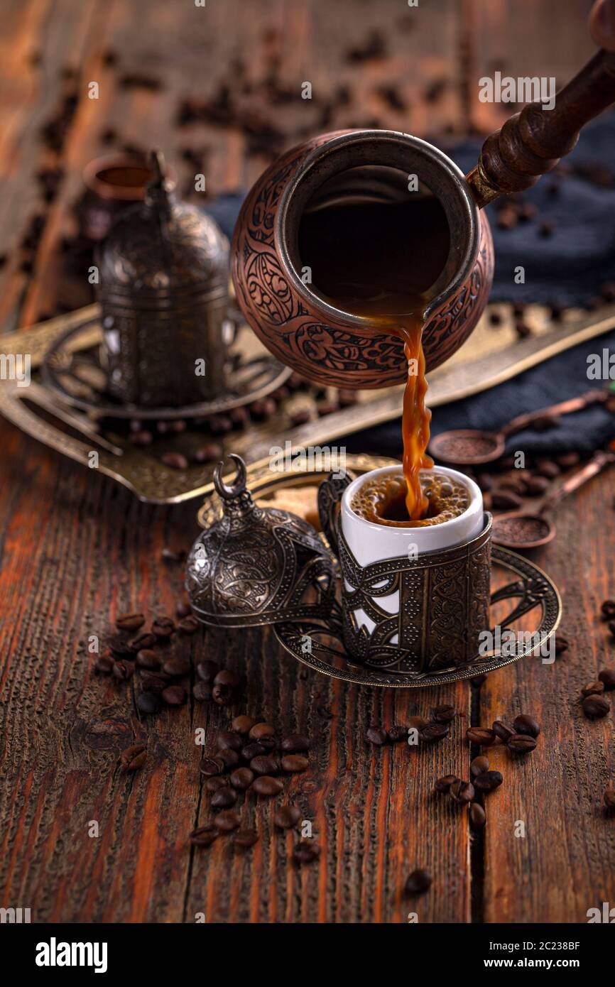 Pouring Turkish coffee into a traditional Turkish cup Stock Photo - Alamy
