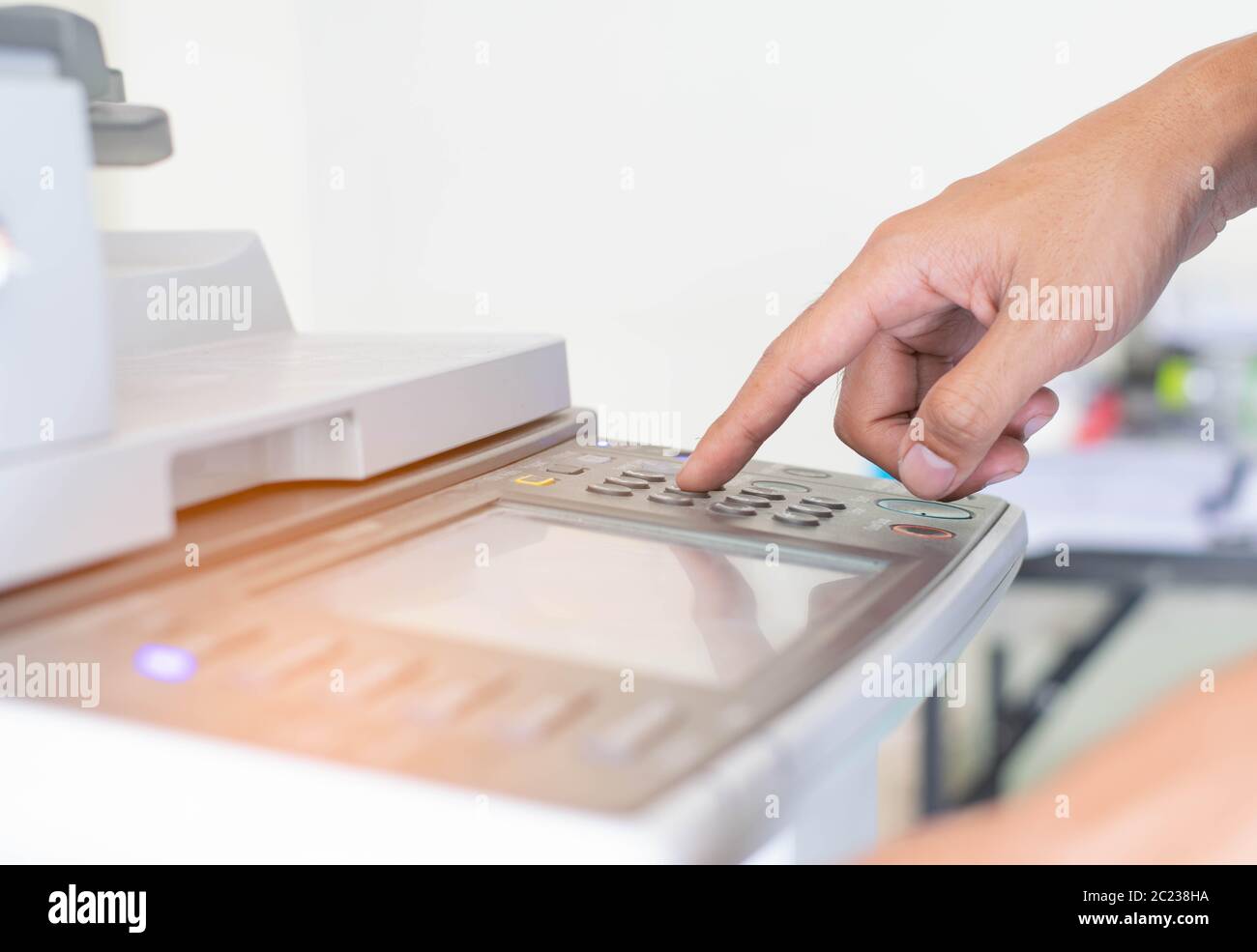 a man is pressing the botton of printer Stock Photo - Alamy