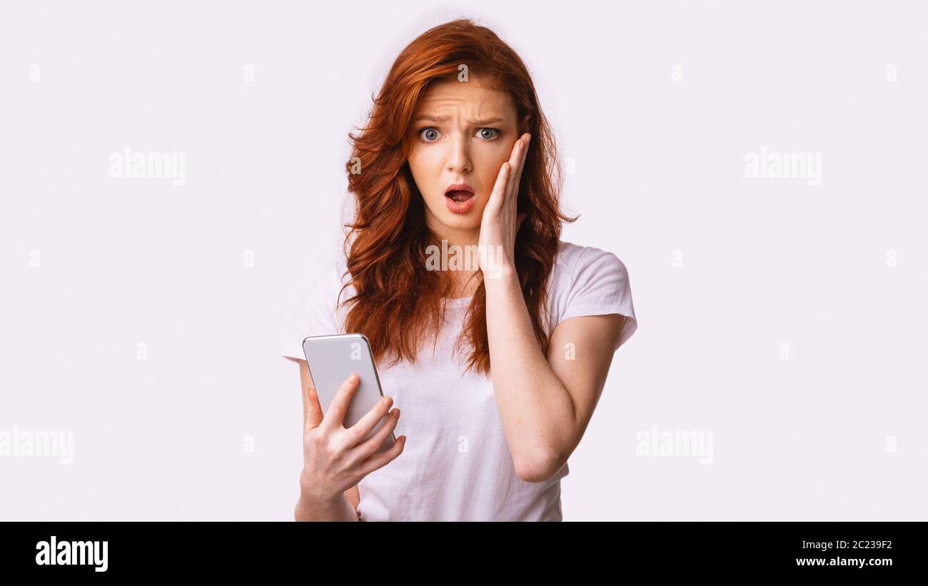 Teen Girl Holding Cellphone Reading Embarassing Message Over White ...