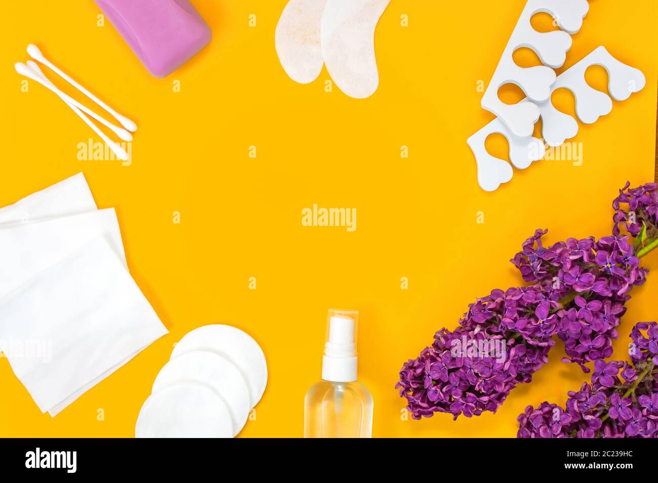 Hygiene products and lilac flowers laid out as a frame. Soap, patches ...