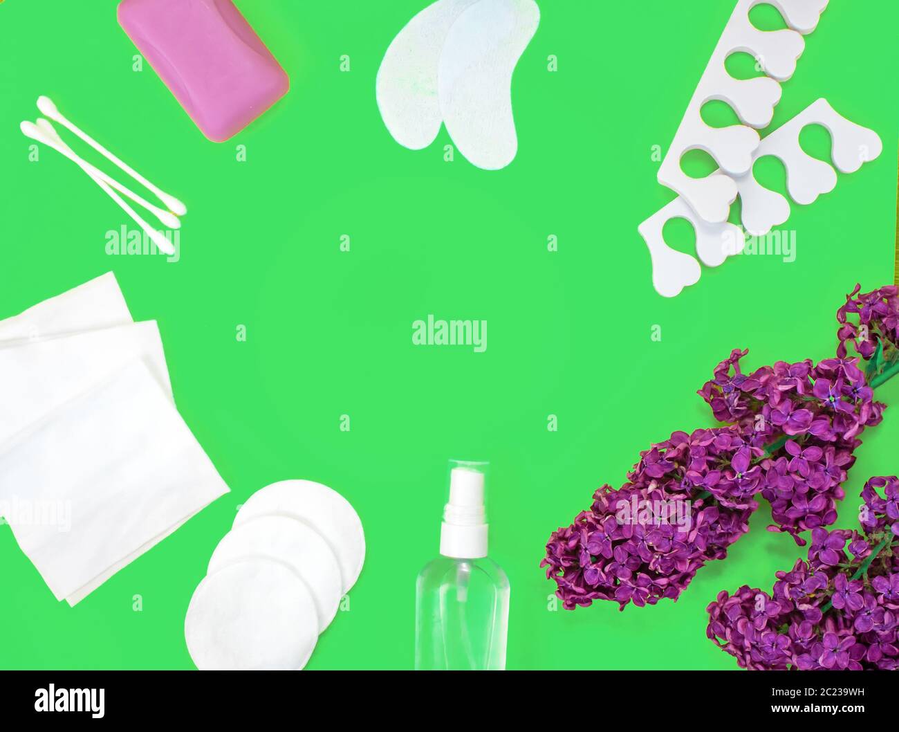 Hygiene products and lilac flowers laid out as a frame. Soap, patches ...
