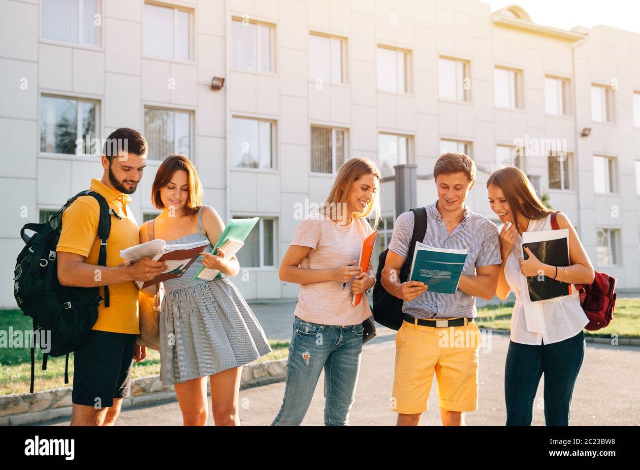 Classmate. Group of cheerful students teenagers with note books are ...