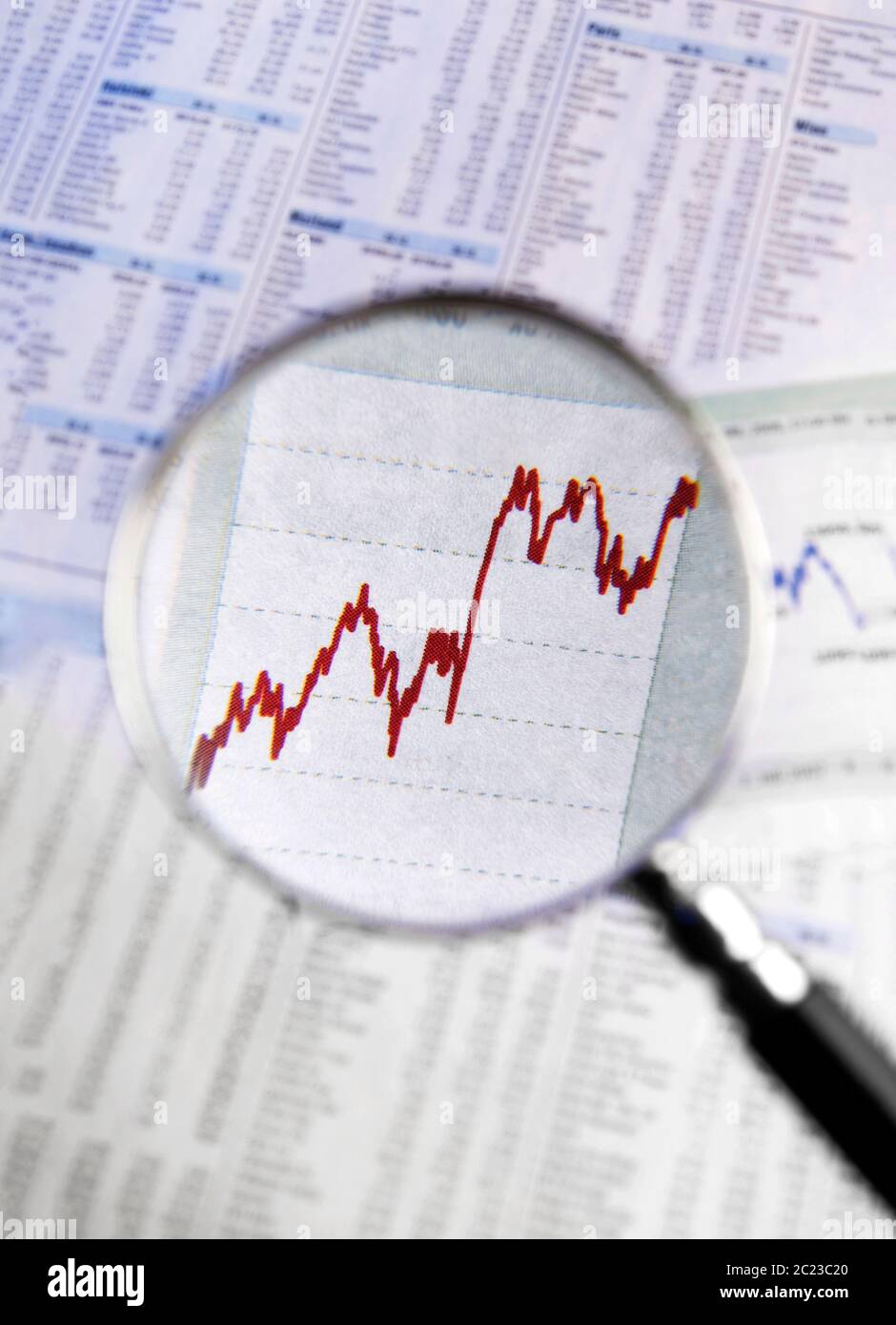 Magnifying glass focused increasing market price Stock Photo - Alamy