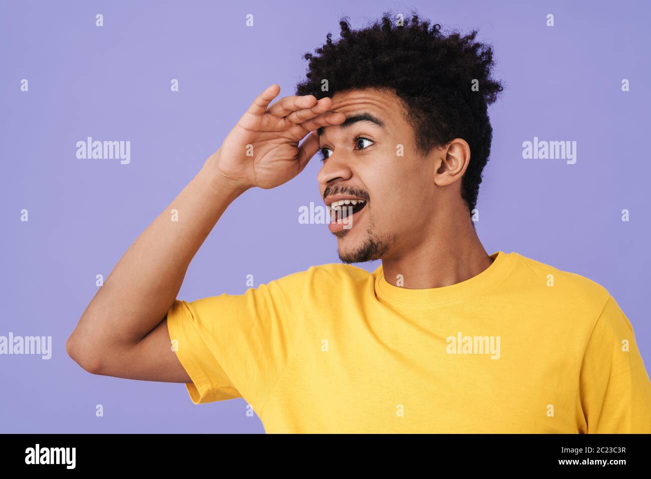 Photo of excited african american man looking aside and expressing ...