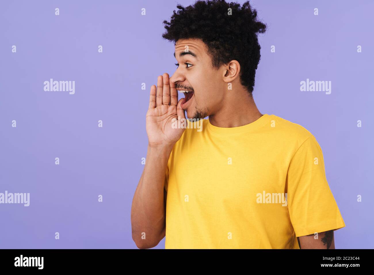 Photo of excited african american man looking aside and screaming ...