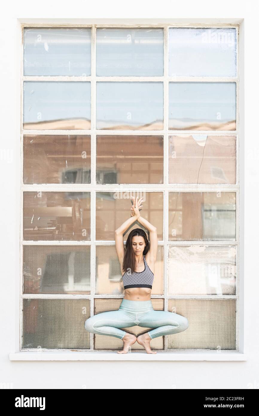 Fit sporty active girl in fashion sportswear doing yoga fitness ...