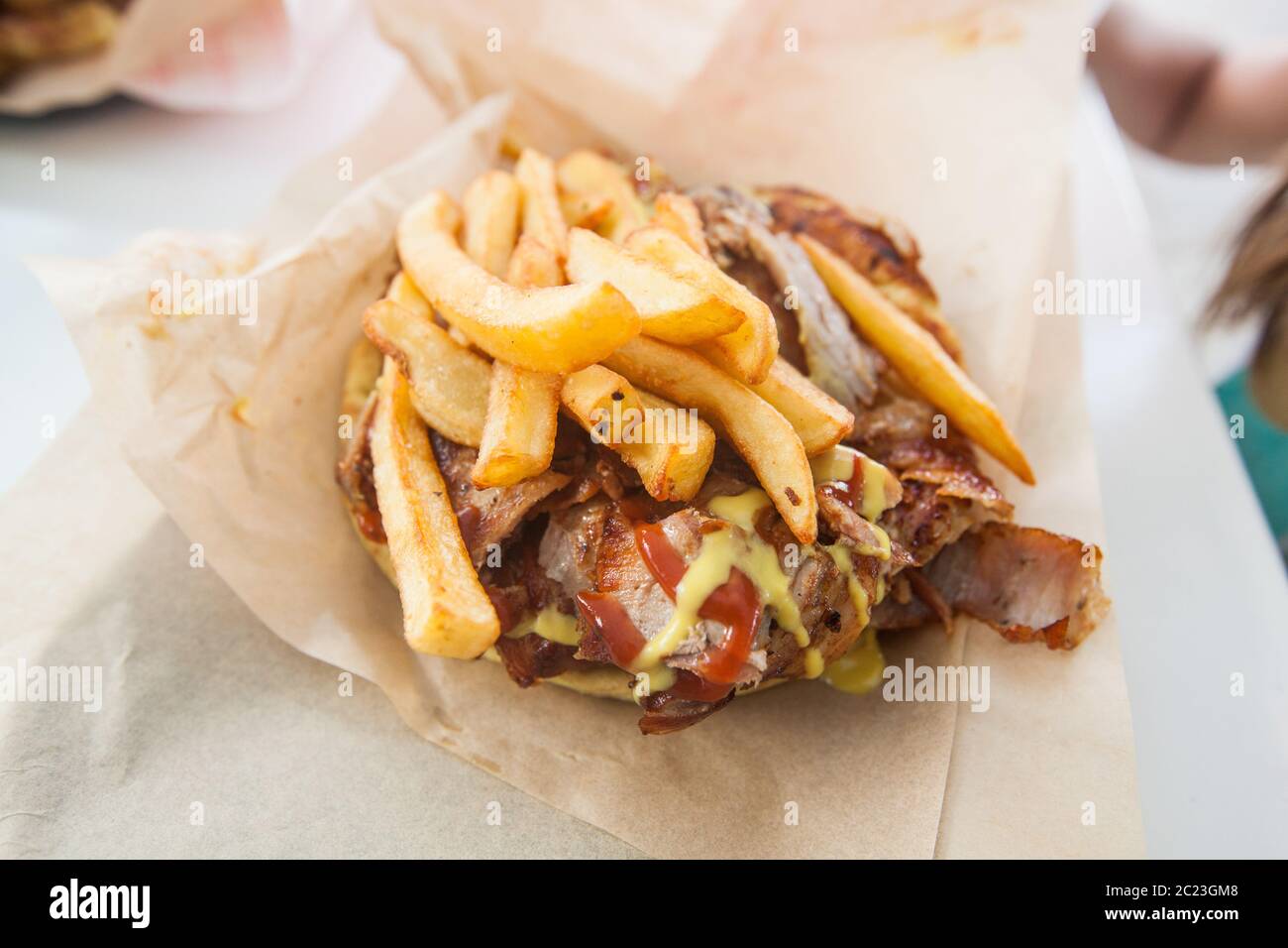 Gyros traditional Greek fast food. Sliced grilled pork meat with fried ...