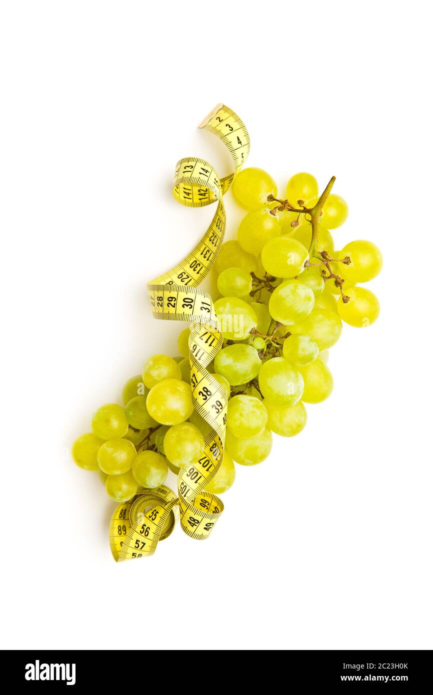 Tasty green grapes. White grape and measuring tape isolated on white ...