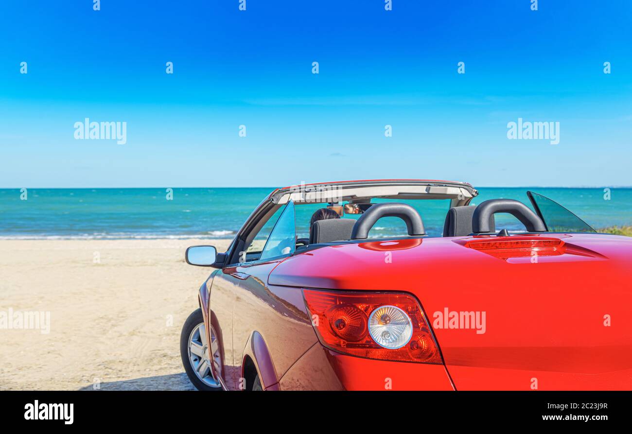 Red car on the beach Stock Photo - Alamy