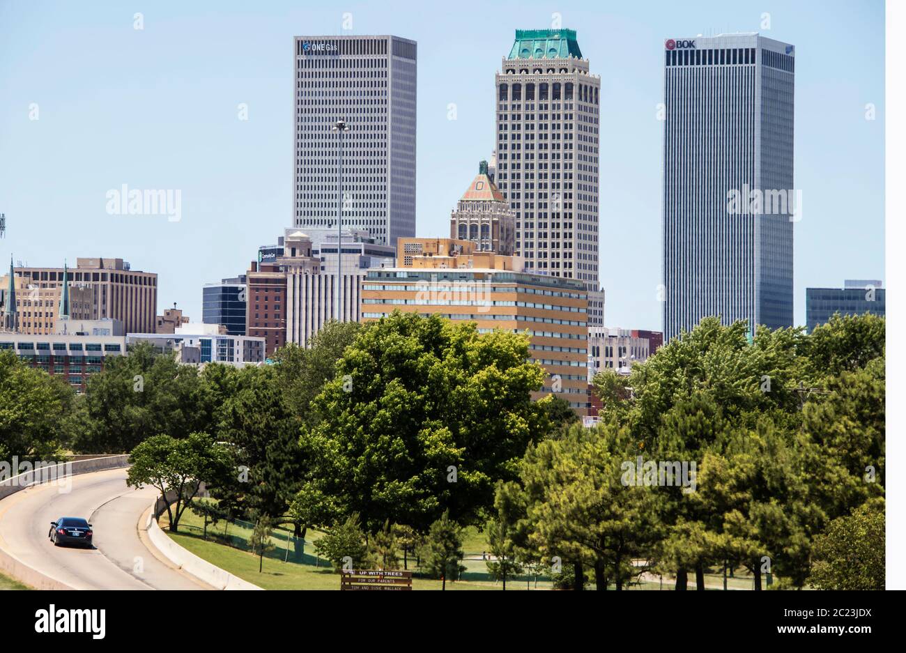 06-13-2020 Tulsa USA Street leading into city with car around parkland ...