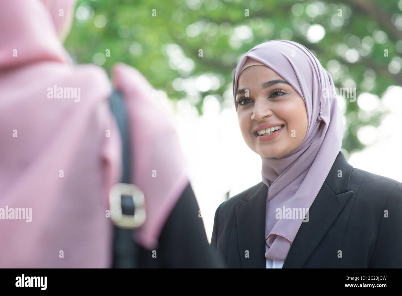 Beautiful Muslim business woman talking and smile Stock Photo - Alamy