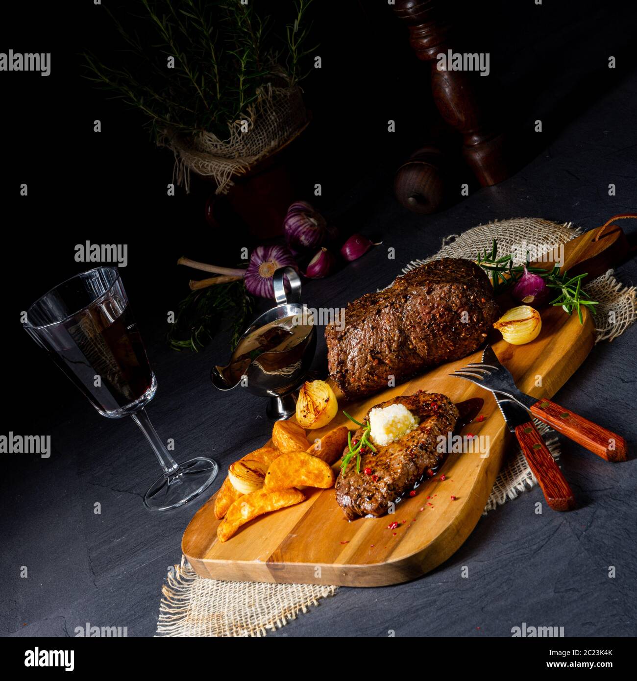 Butter Beef Steak with herbs and potato wedges Stock Photo - Alamy