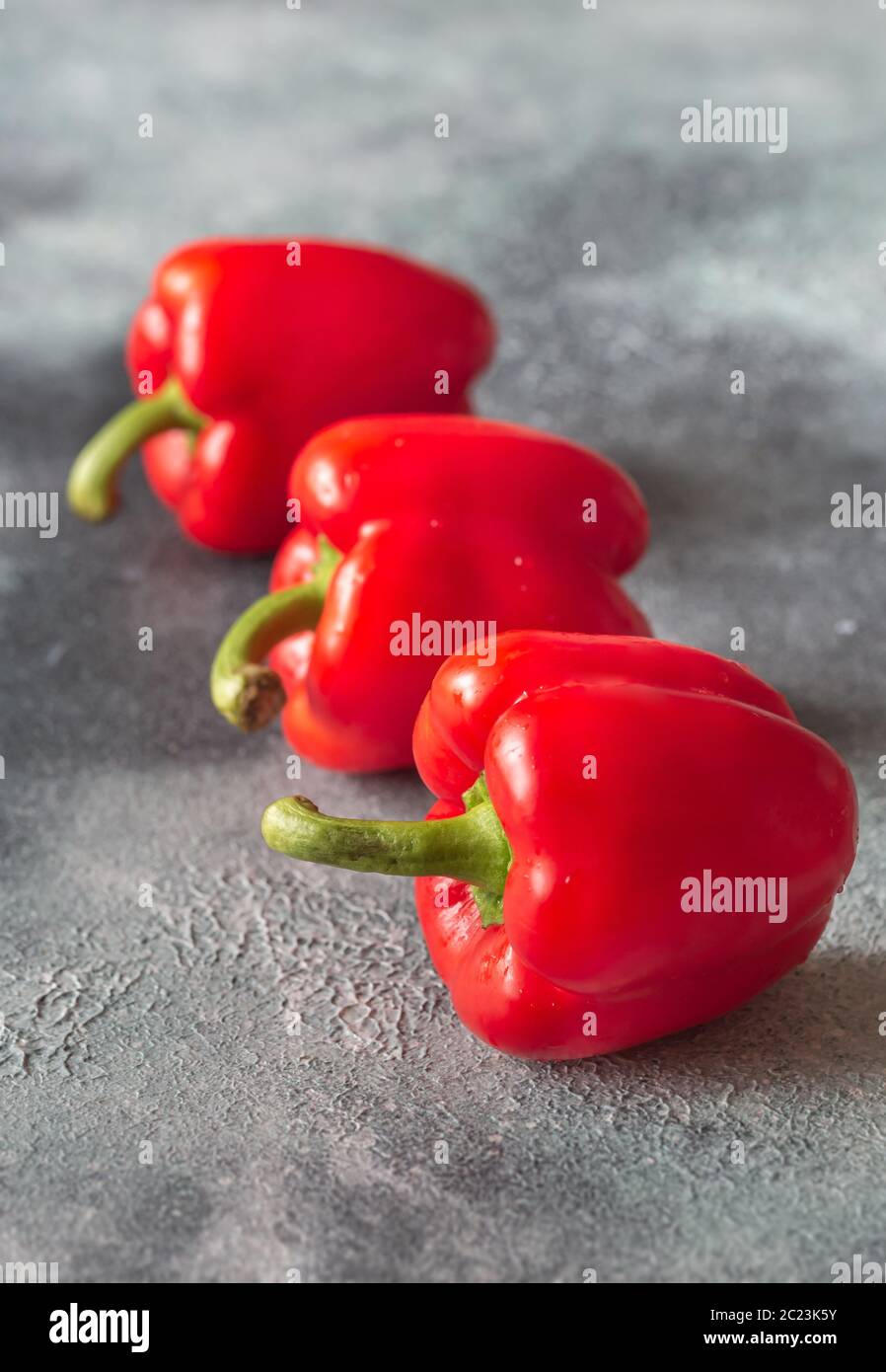 Three fresh red peppers Stock Photo - Alamy