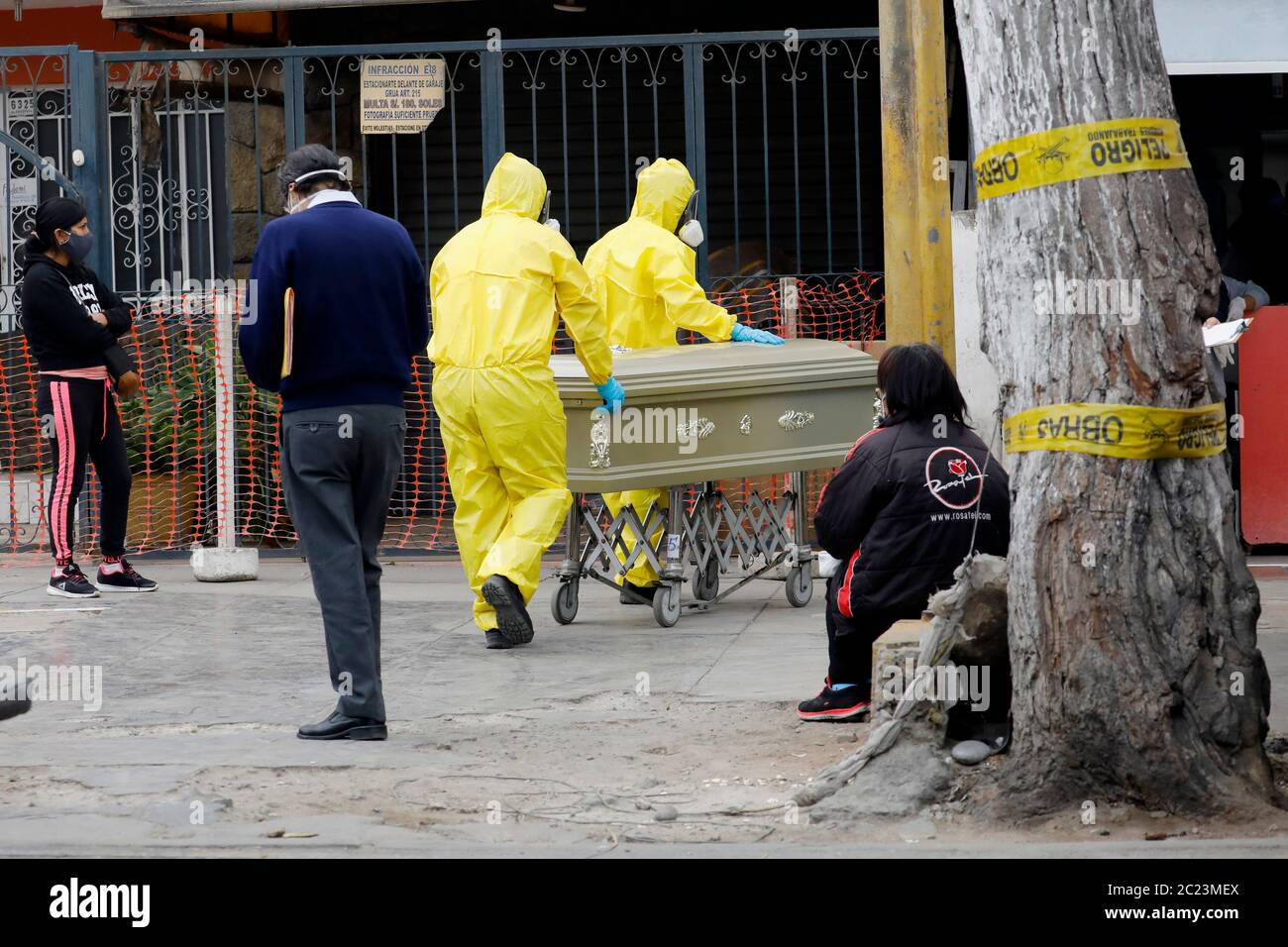 Lima, Peru. 15th June, 2020. Funeral workers carry a coffin outside ...