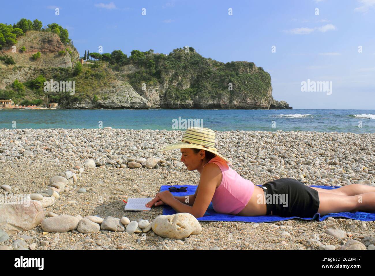 Reading on the beach Stock Photo - Alamy