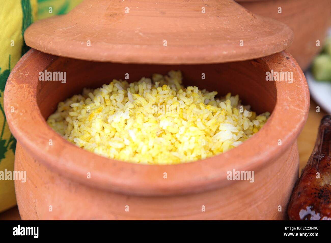 White and yellow rice garnish in brown pot Stock Photo - Alamy