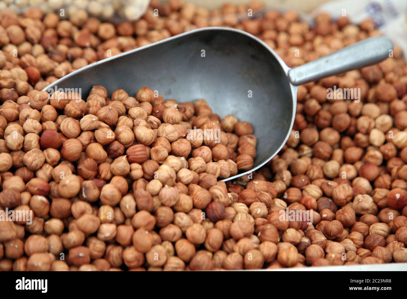 Dry nuts in the stock with metallic spoon to take Stock Photo - Alamy