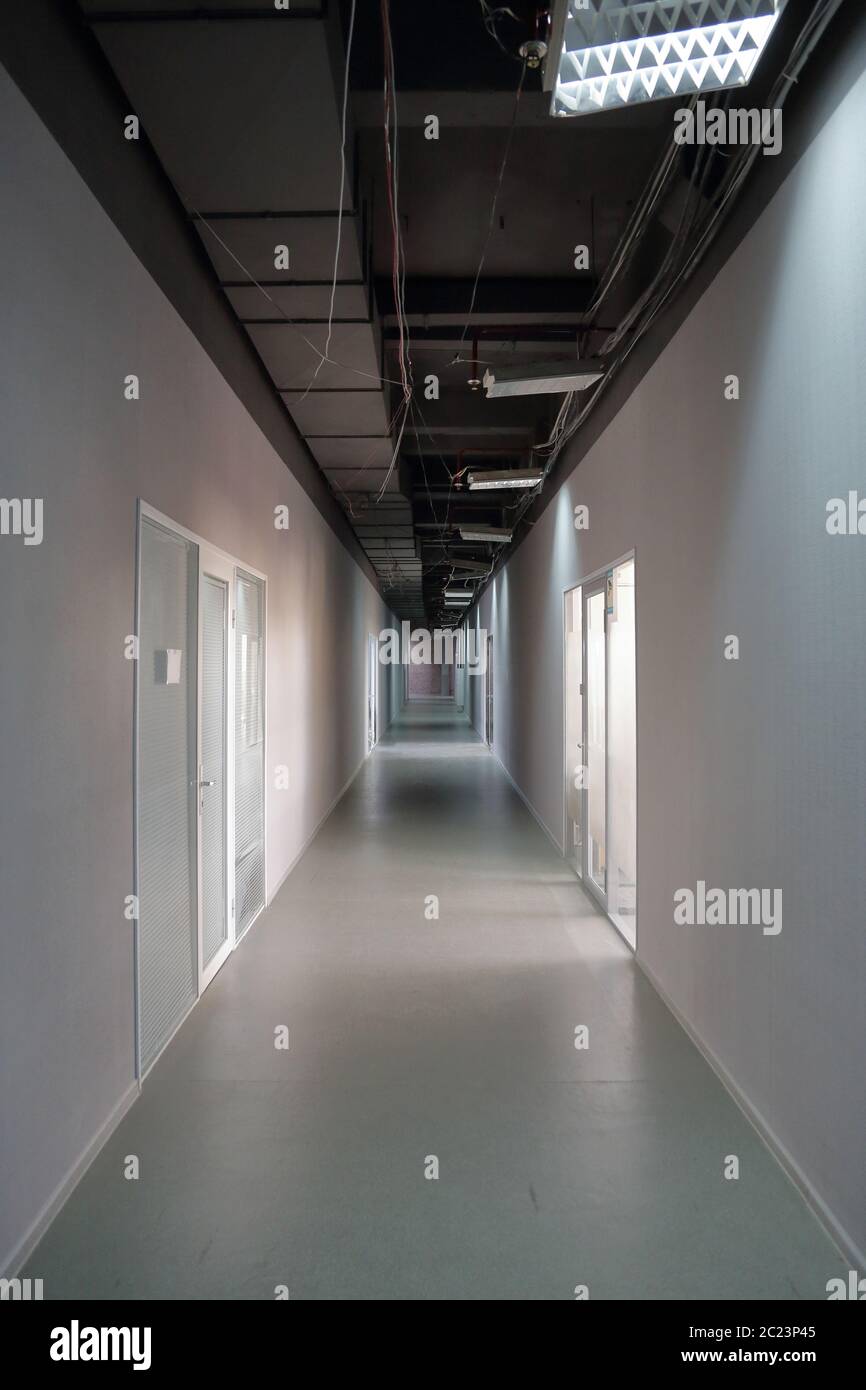 Long narrow corridor with doors in the office or workplace Stock Photo ...