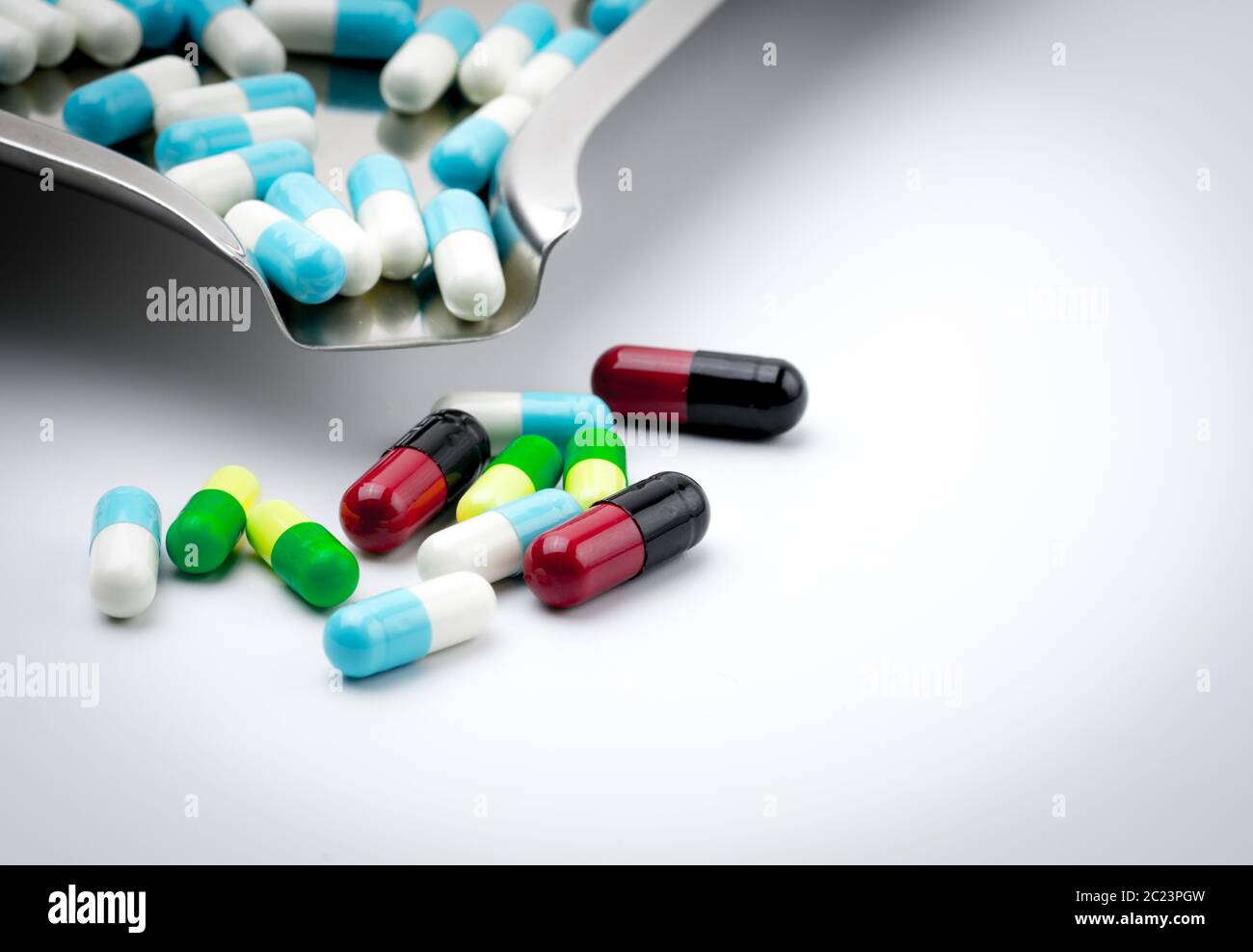 Colorful capsule pills on stainless steel drug tray on white background ...
