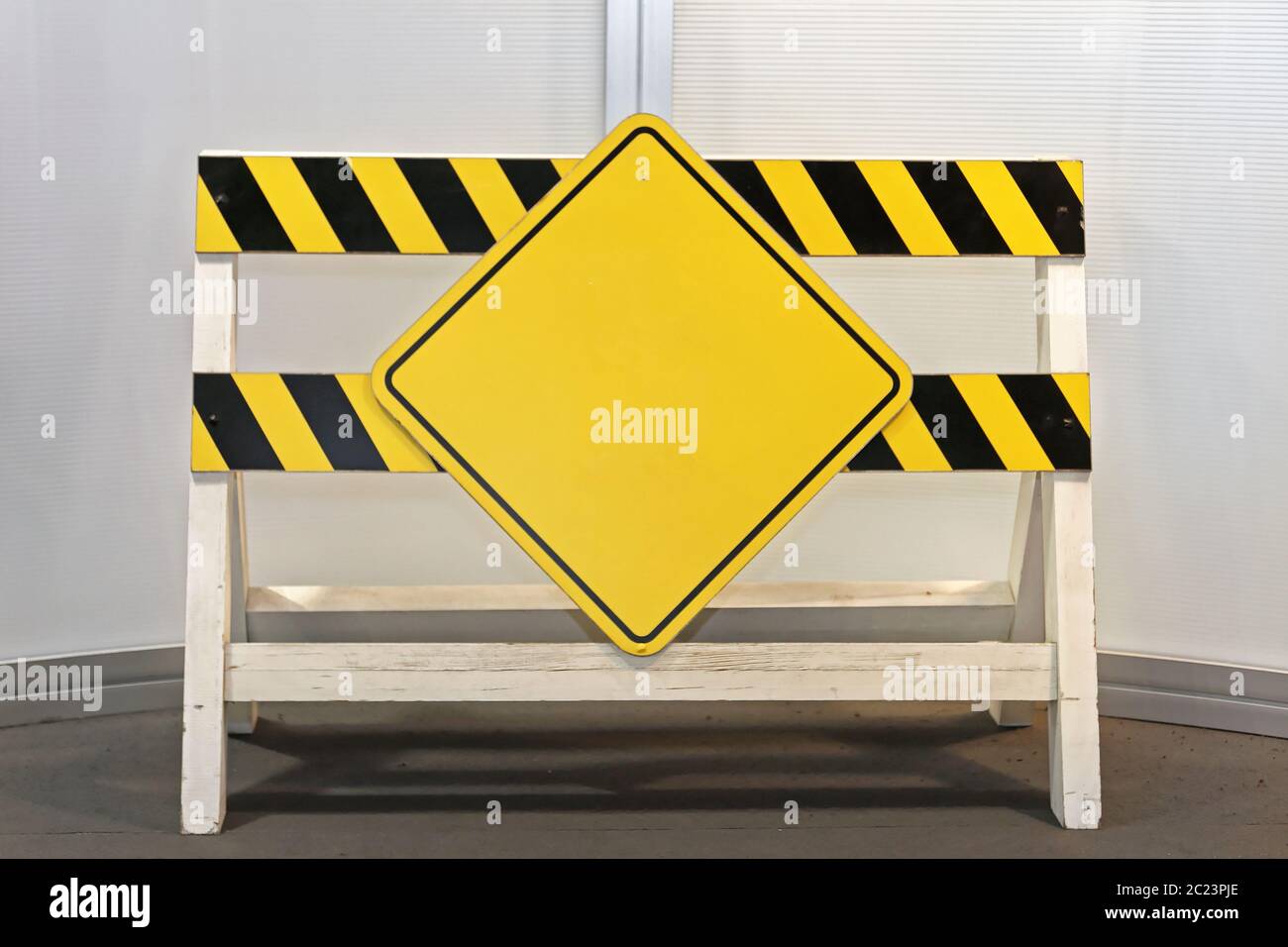 Construction Site Barrier With Yellow Warning Sign Stock Photo - Alamy