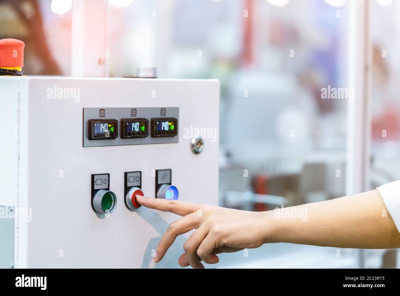 Engineer's hand push red button to shutdown temperature control machine ...