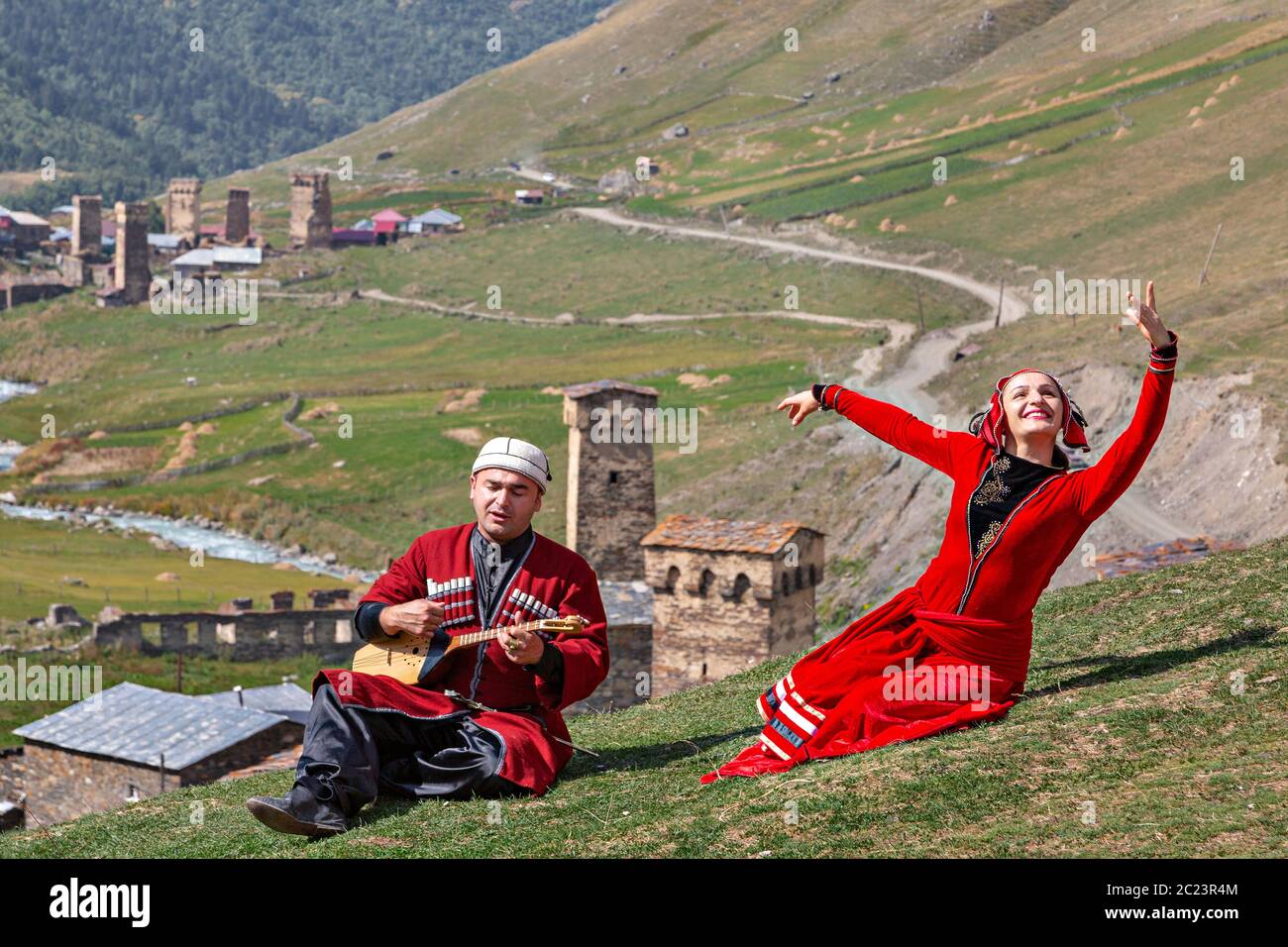 Georgian woman dances and Georgian man plays locan musical instrument ...