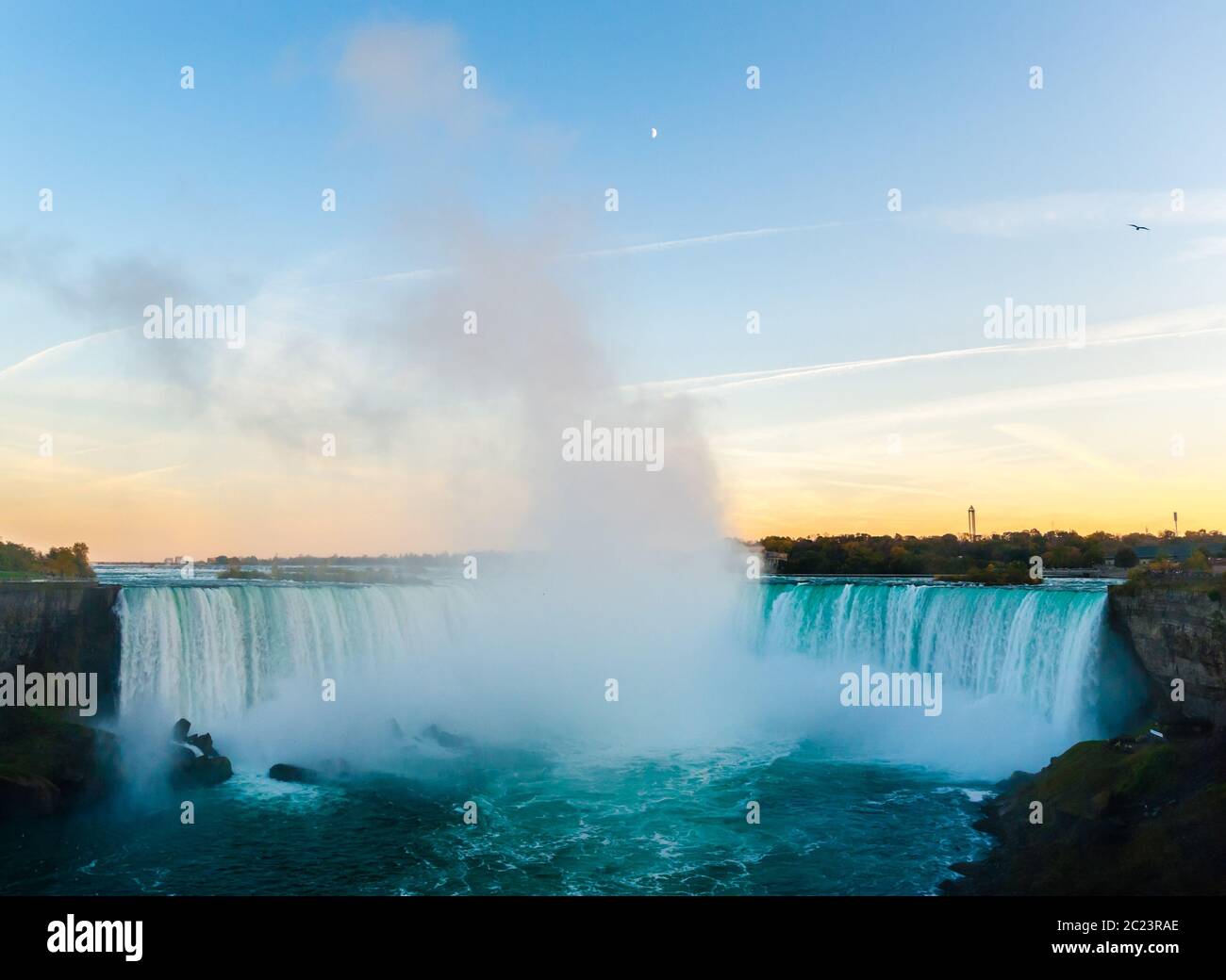 Horseshoe Falls in evening with water spray rising under moon, at ...