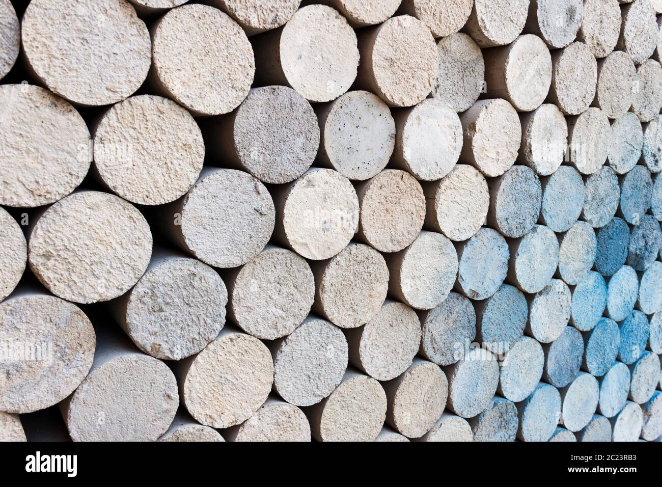 Pile of concrete cylinder bricks. Storage of cylindrical cement samples ...