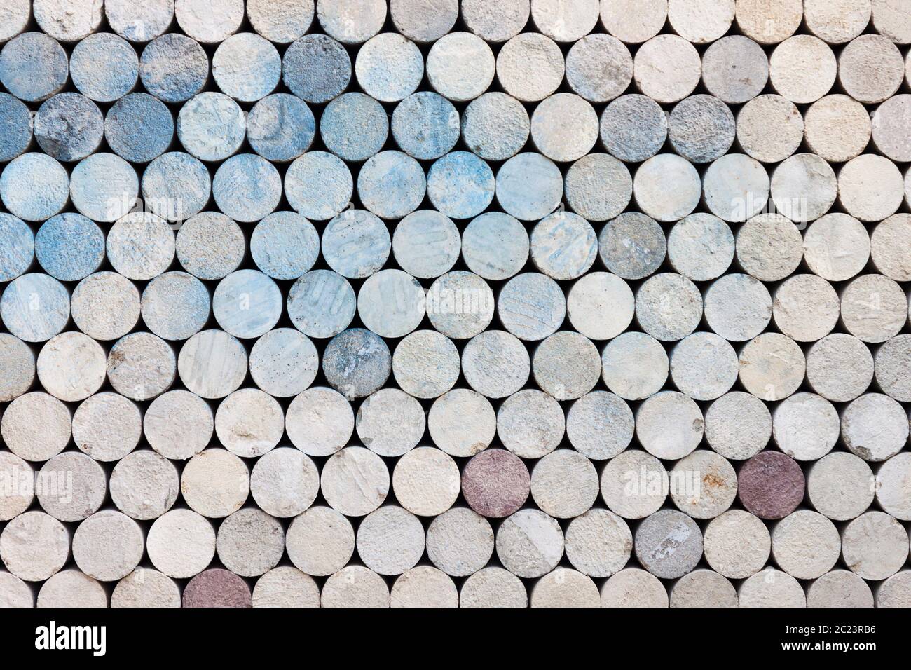 Pile of concrete cylinder bricks. Storage of cylindrical cement samples ...