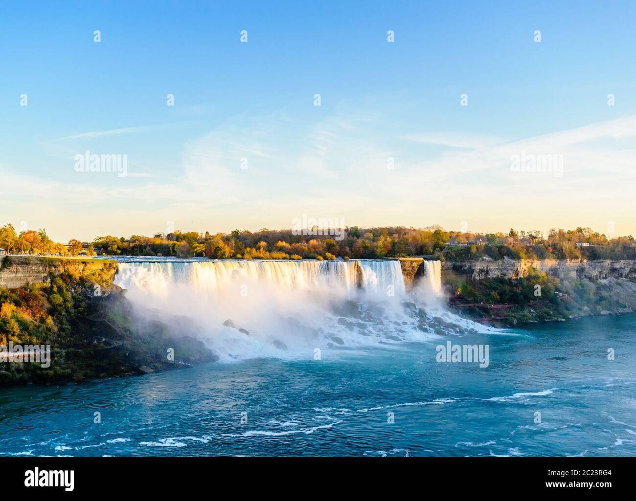 American Falls illuminated by setting sun in autumn, seen from Niagara ...