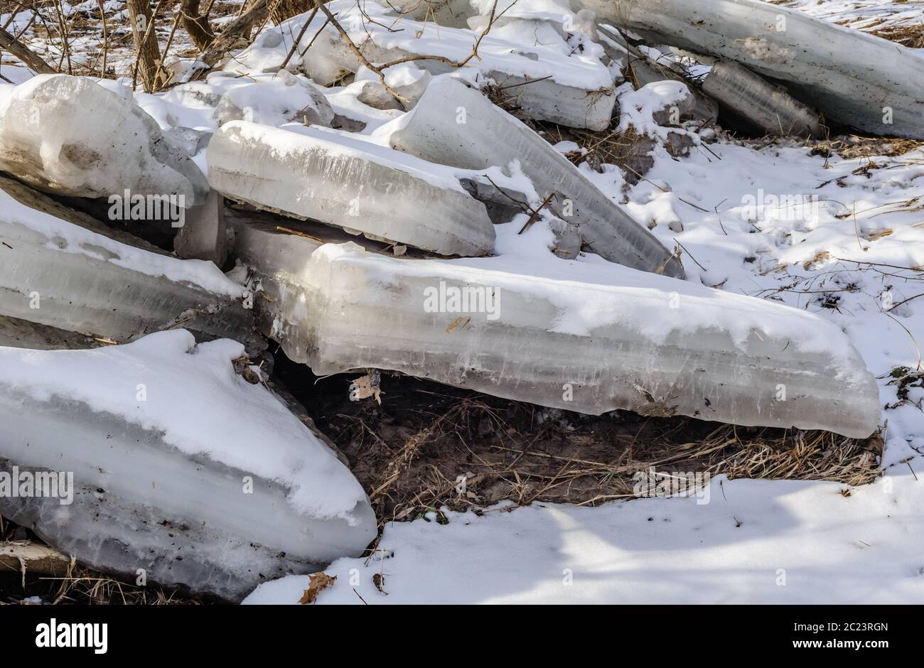 Thick slabs of frozen ice broken and piled on shore in winter Stock ...