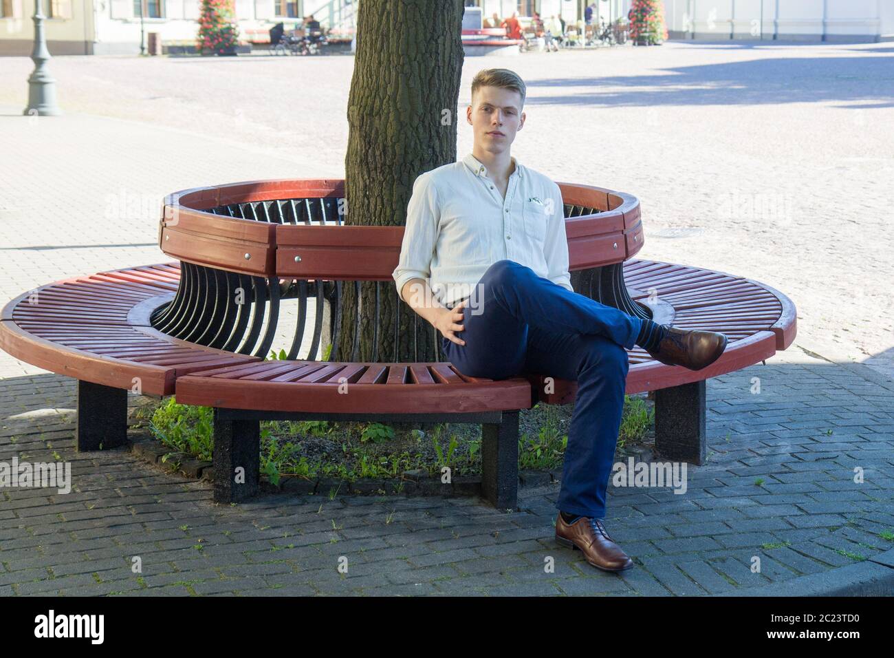 Resting male man sitting in a street bench hi-res stock photography and ...