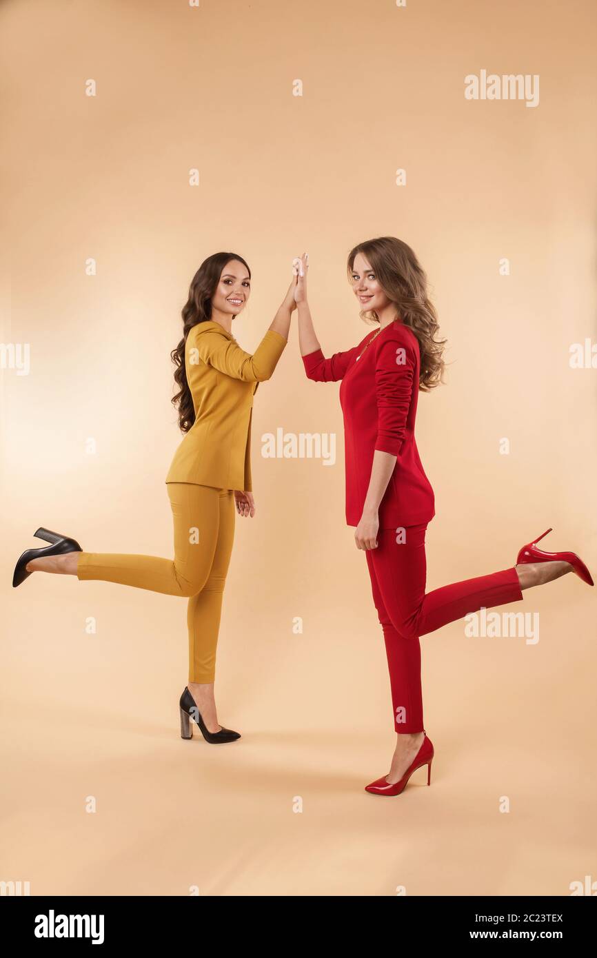 Two young women giving high five hi-res stock photography and images ...