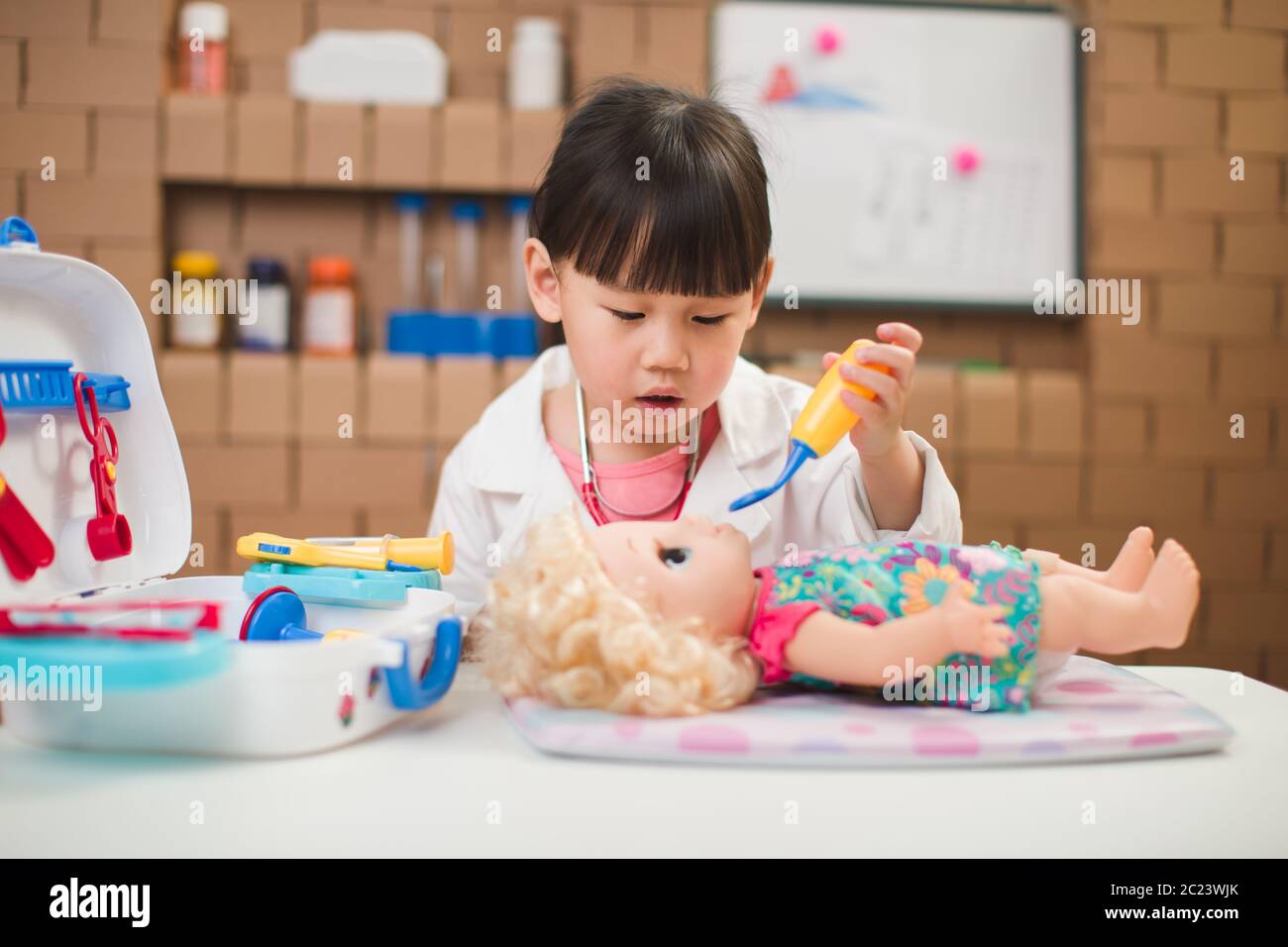 toddler girl pretend play doctor role at home Stock Photo - Alamy