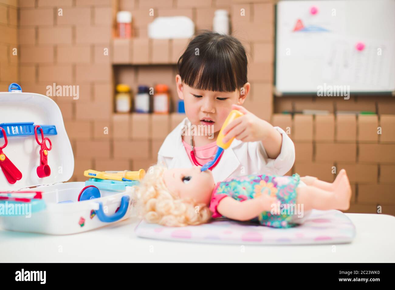 toddler girl pretend play doctor role at home Stock Photo - Alamy